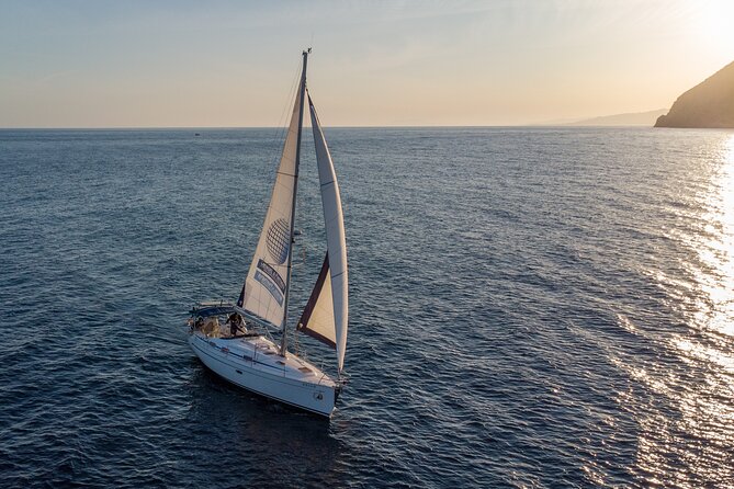 Sunset sailing along the cliffs of Maro- Private - The Sum Up