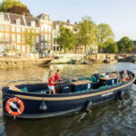 Amsterdam: Guided Open Boat Canal Cruise Including Drink - What to Expect from the Tour
