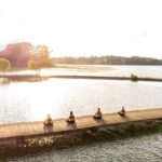 Relax and nature: Yoga lesson on the shore of the lake with picnic - The Yoga Lesson: A Holistic Practice