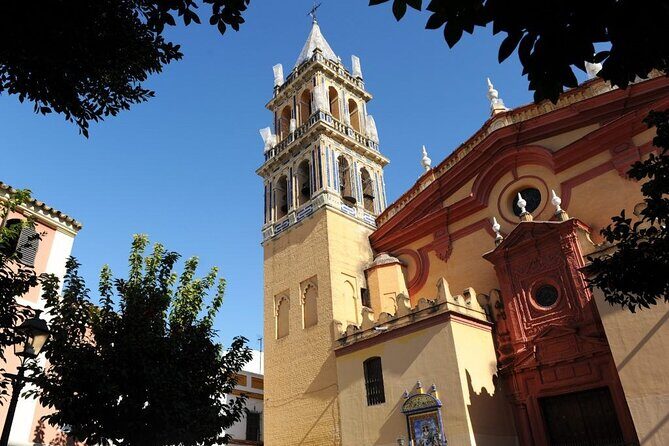 Discover the River and the Secrets of Triana Quarter in Seville - Delving into Triana’s History: Castle of San Jorge and Religious Heritage