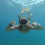 Snorkeling with turtle and statue in Gilis - The Value Factor