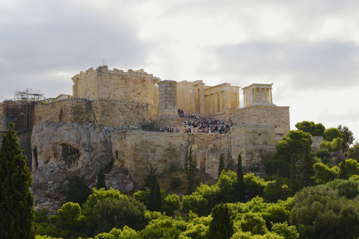 View of the Acropolis Athens surrounded by lush greenery during daytime