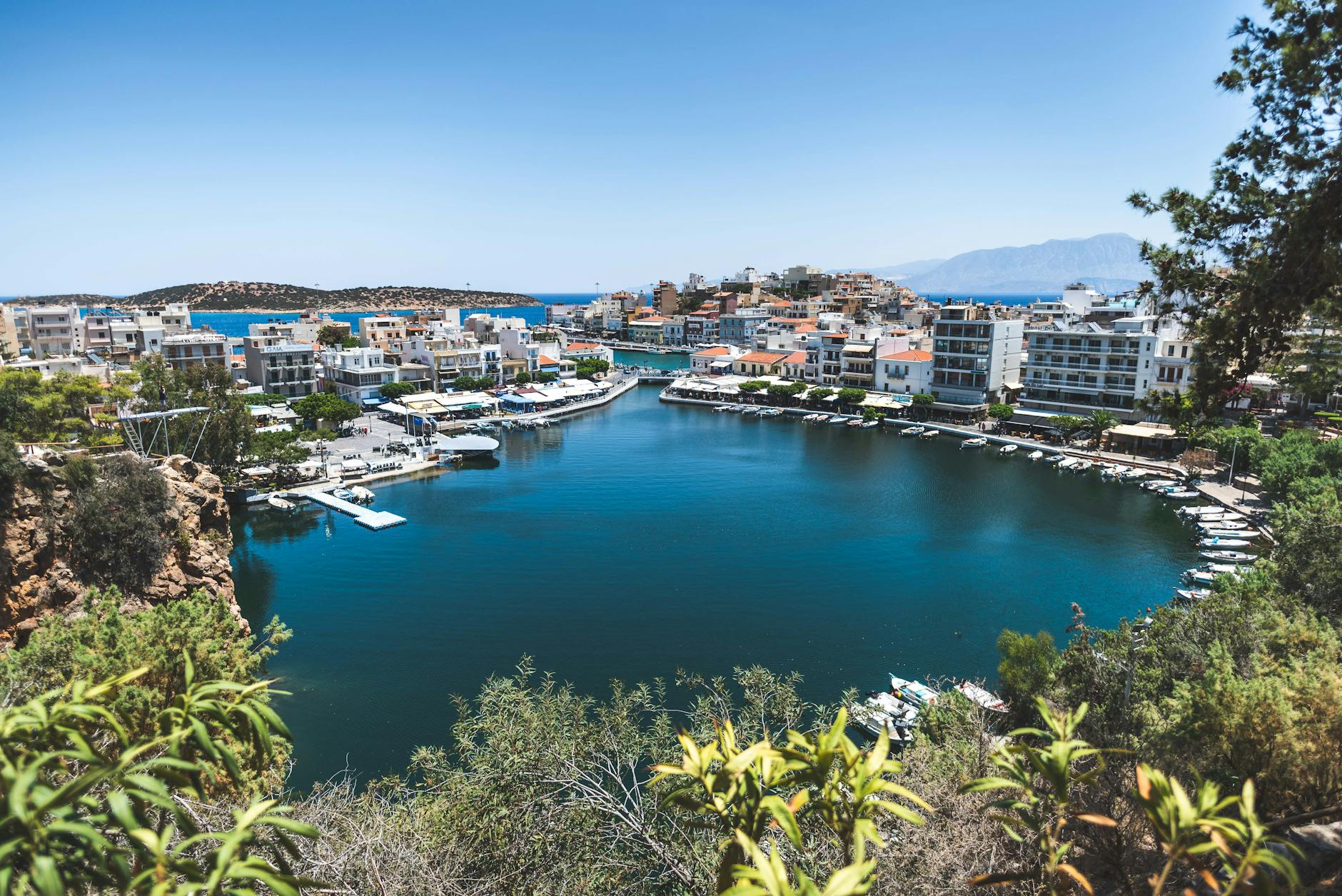 Agios Nikolaos harbor with boats and lakeside town