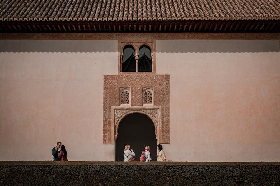 Visitors at Alhambra arched doorway Granada