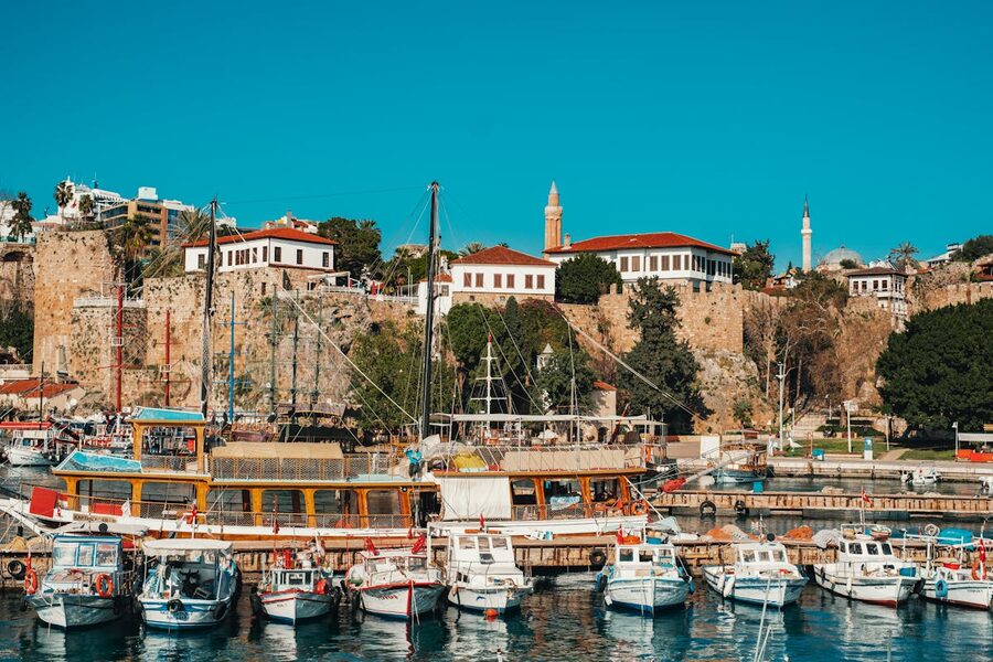 Antalya harbor with ancient fort and boats moored along the waterfront