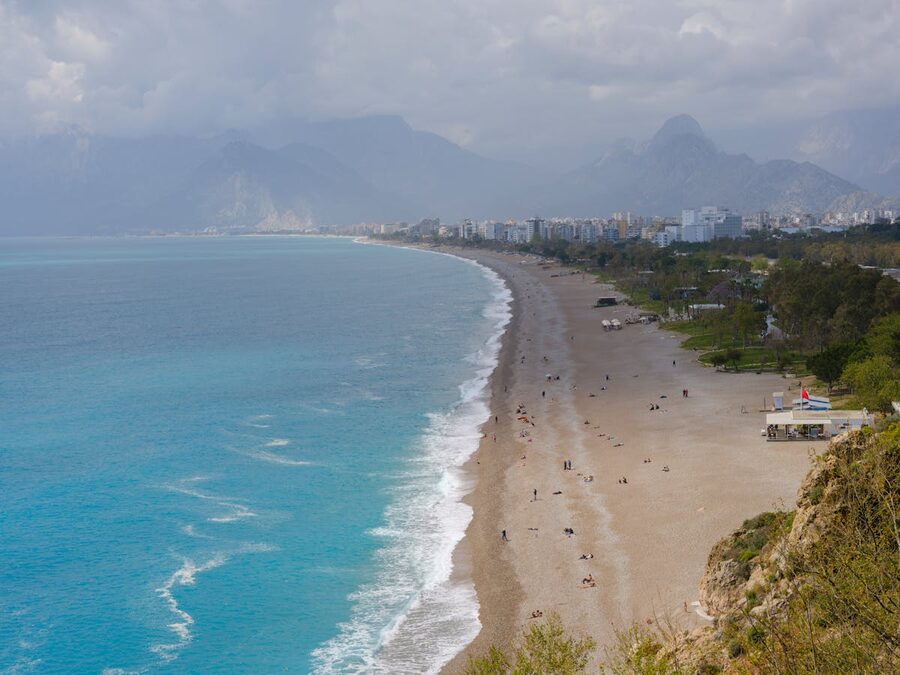 Aerial view of Konyaalti Beach in Antalya with city and mountains stretching along the coast
