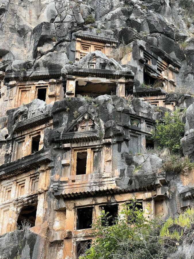 Wide view of Lycian rock tombs above the ancient theater at Myra Turkey