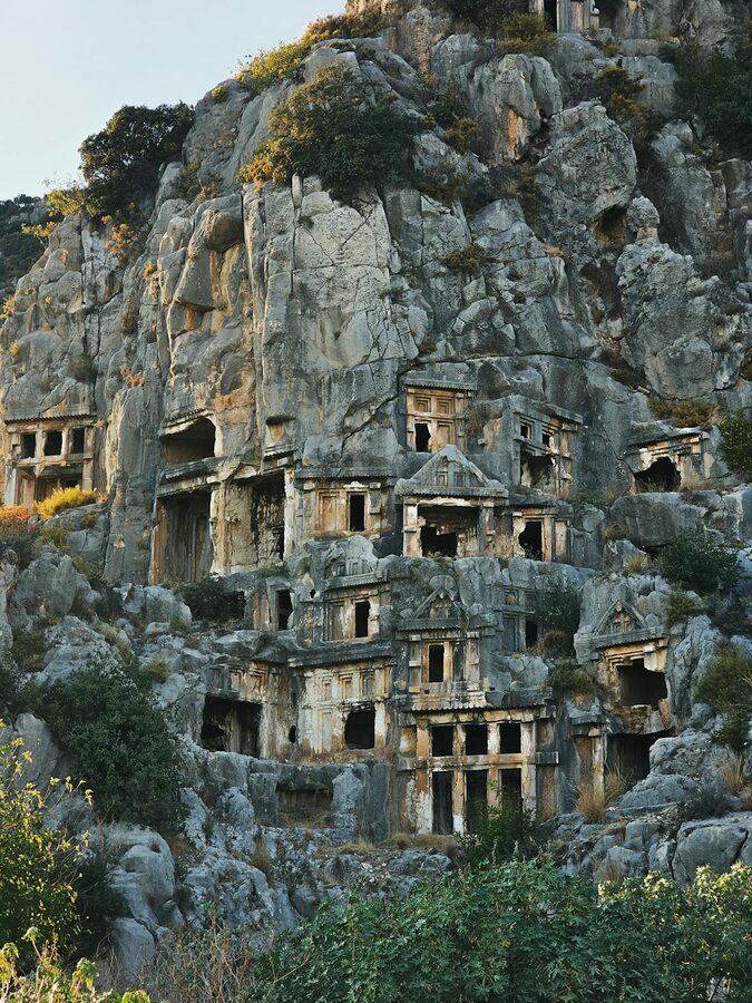 Ancient Lycian rock-cut tombs carved into cliff face at Myra Demre Turkey