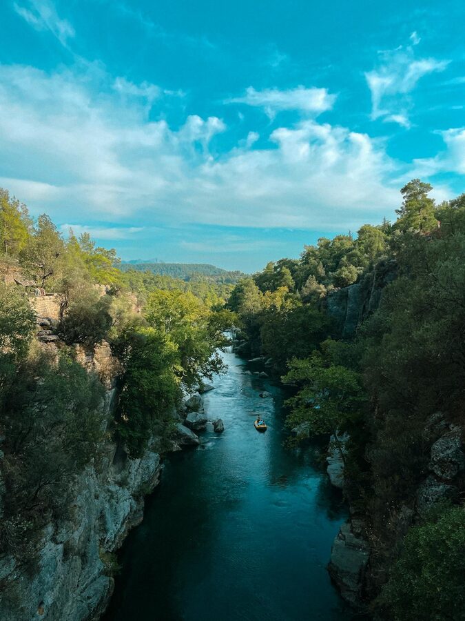 River flowing through lush green Koprulu Canyon with steep walls in Antalya