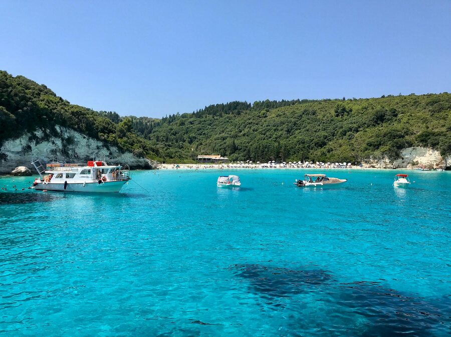 Turquoise waters with boats near the Antipaxos coastline
