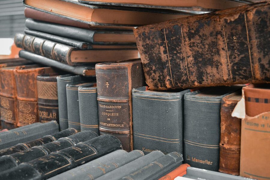 Collection of antique leather-bound books stacked together