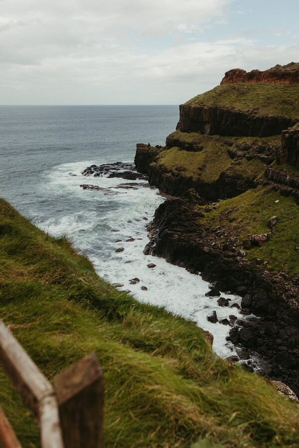 Cliffs and ocean waves along the Antrim coast Northern Ireland