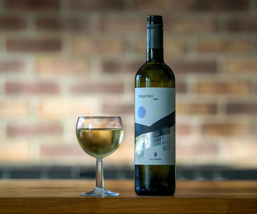Bottle of Assyrtiko Greek white wine with filled glass