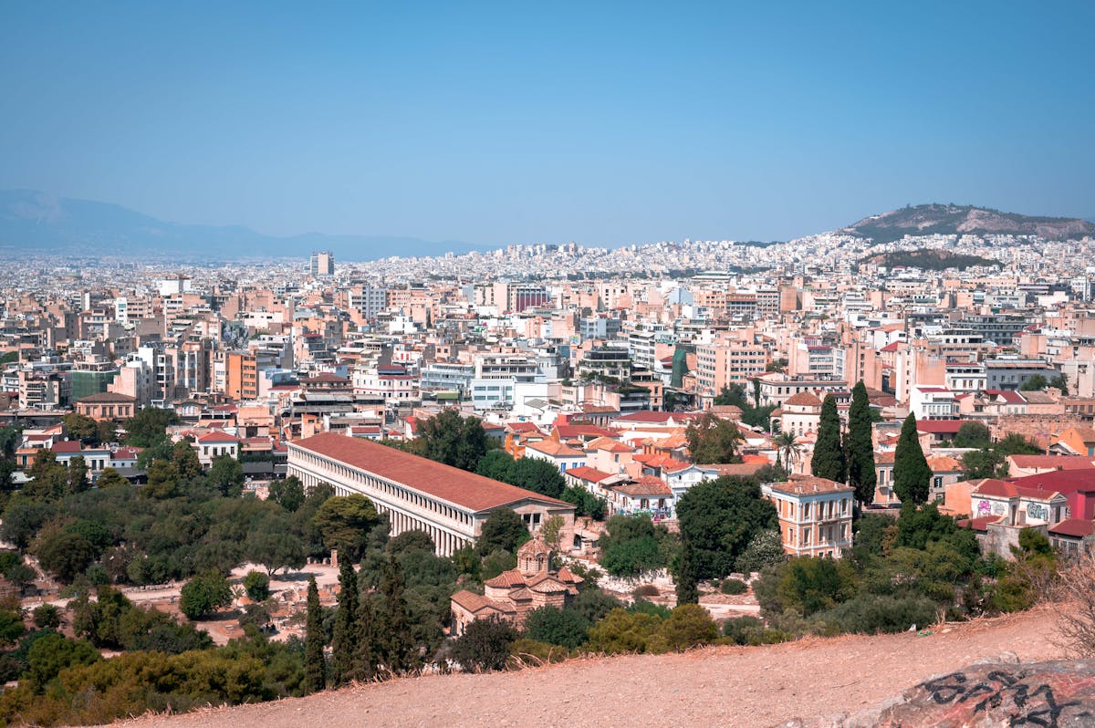 Aerial view of Athens cityscape showing the Acropolis and ancient landmarks