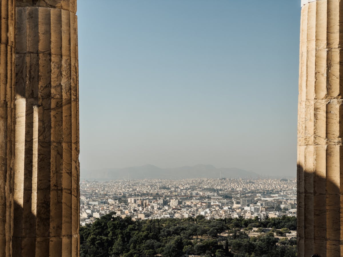 View of Athens city through historical columns on the Acropolis