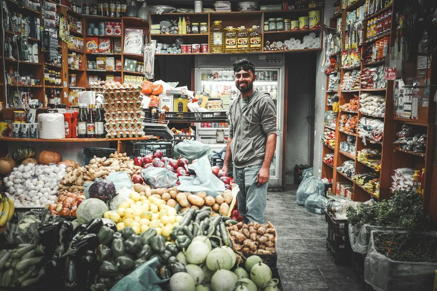 Athens grocery store shopkeeper smiling in his shop