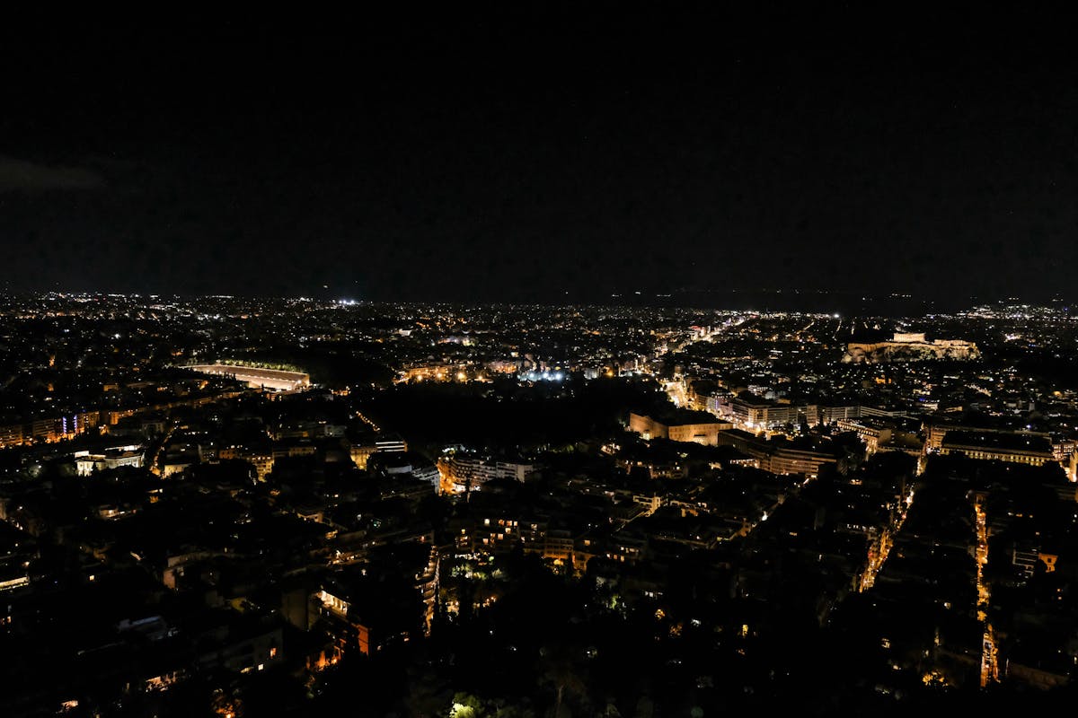 Aerial view of Athens at night showcasing city lights and landmarks