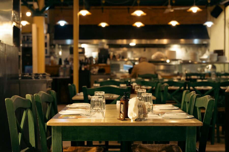 Warm interior of an Athens cafe with set dining tables
