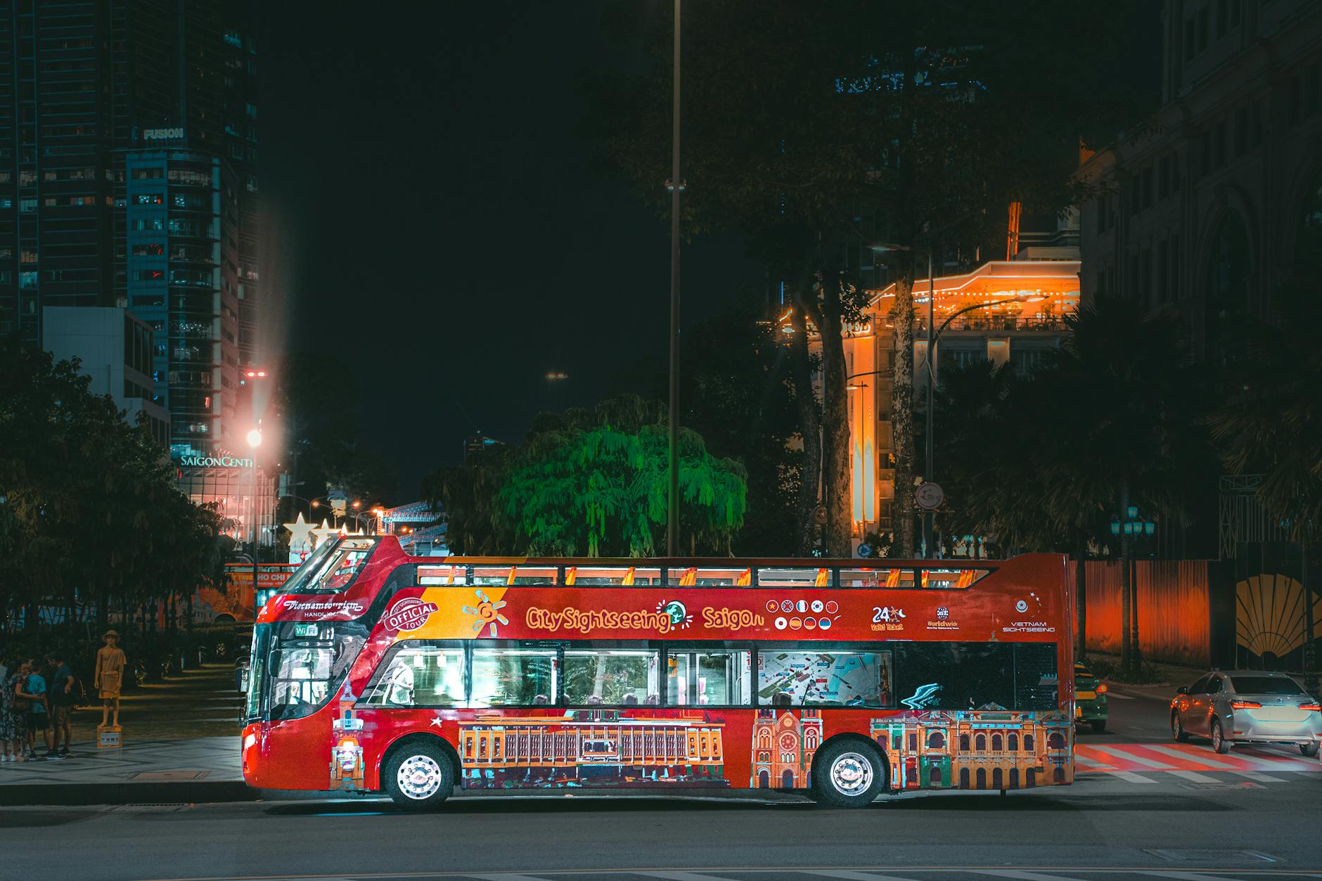 Red sightseeing bus parked at night in Athens