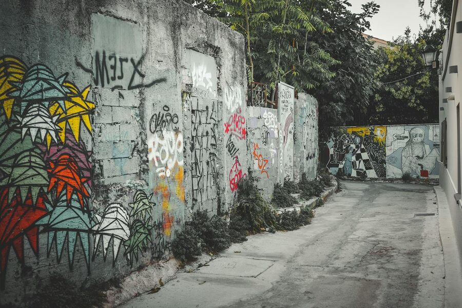 Athens alley decorated with colorful graffiti art and street scene