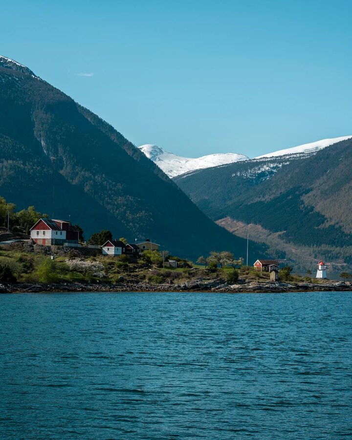 Morning view of Aurlandsvangen village by the fjord with mountains and houses