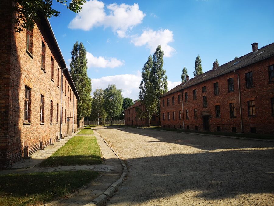 Red brick buildings at Auschwitz under sunny sky