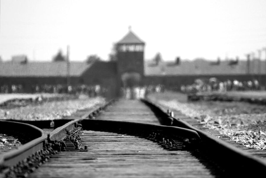 Black and white image of Auschwitz Birkenau railway tracks
