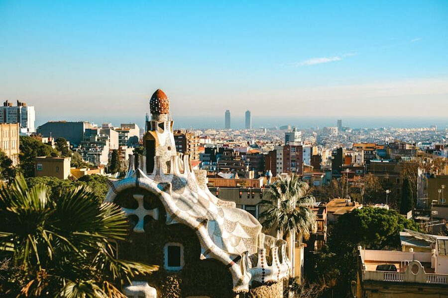 Aerial view of Park Güell showing the main terrace and Barcelona skyline