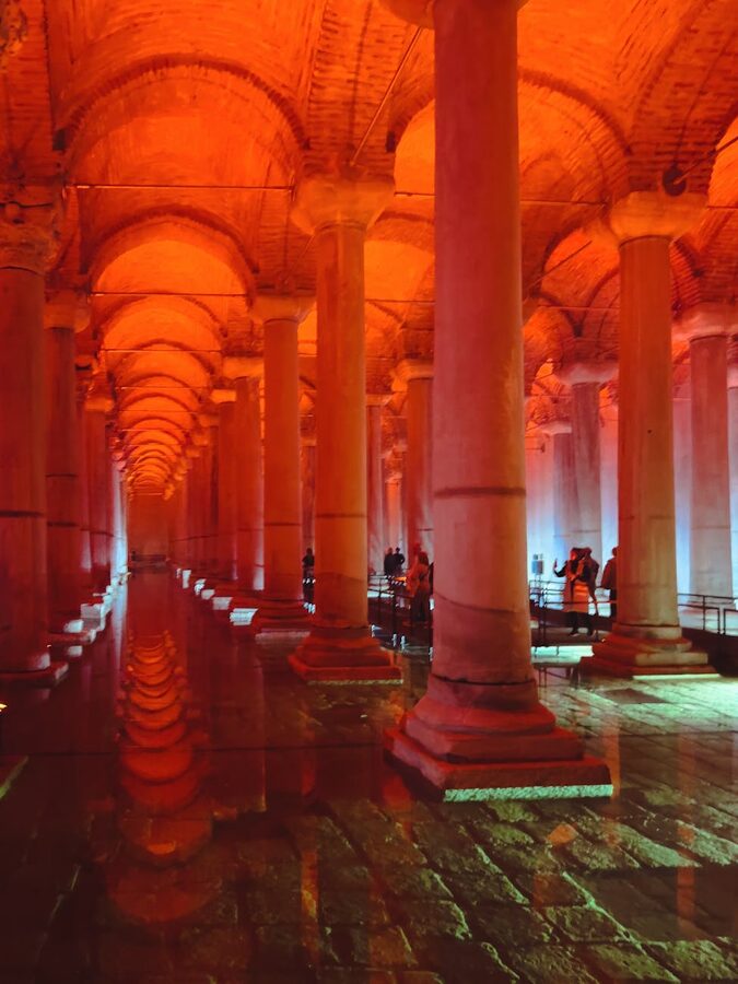 Orange-tinted lighting illuminating the columns of the Basilica Cistern
