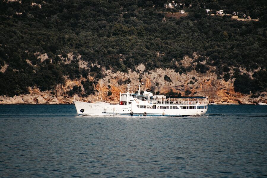 Ferry near forested cliffs near Lopud Croatia
