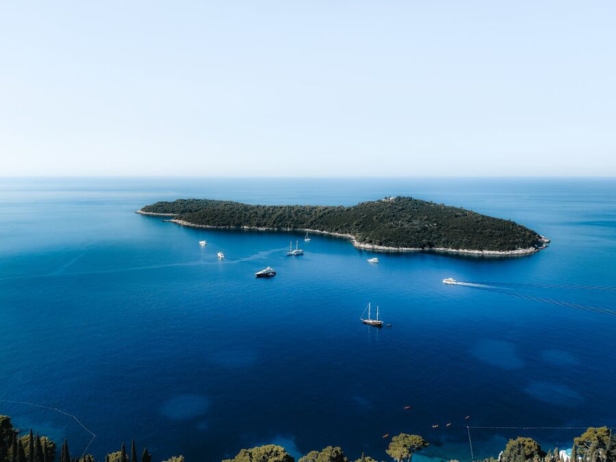 Aerial view of island near Dubrovnik surrounded by turquoise water