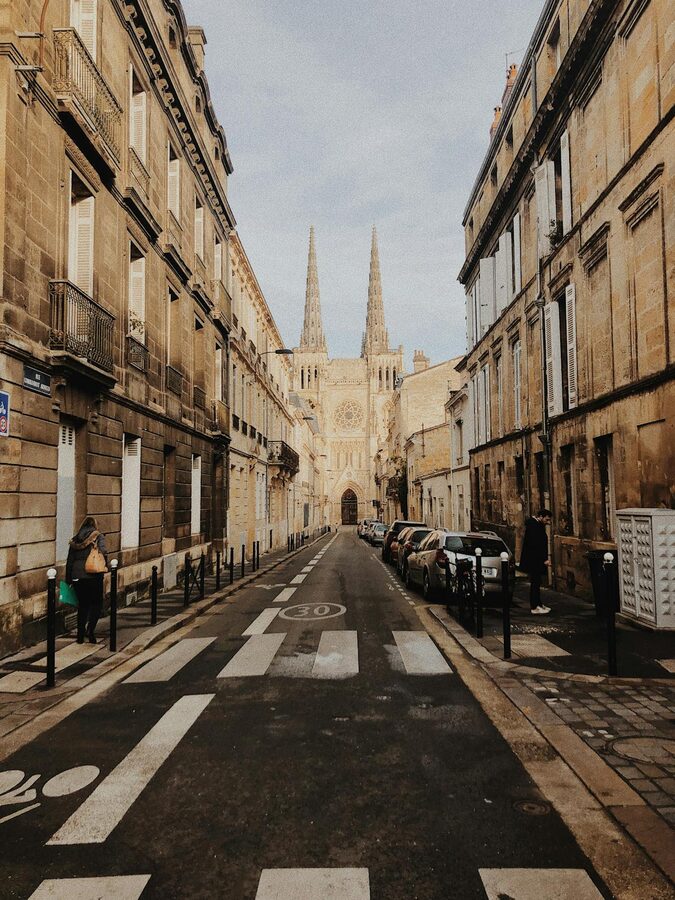 Bordeaux Cathedral viewed from a narrow street with classic French architecture