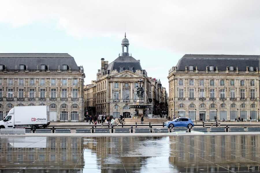 Place de la Bourse reflected in the wet pavement of the Miroir d'Eau on a stunning day