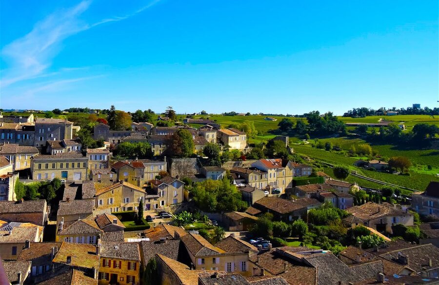 Aerial view of Saint-Émilion village showing medieval rooftops and surrounding vineyards