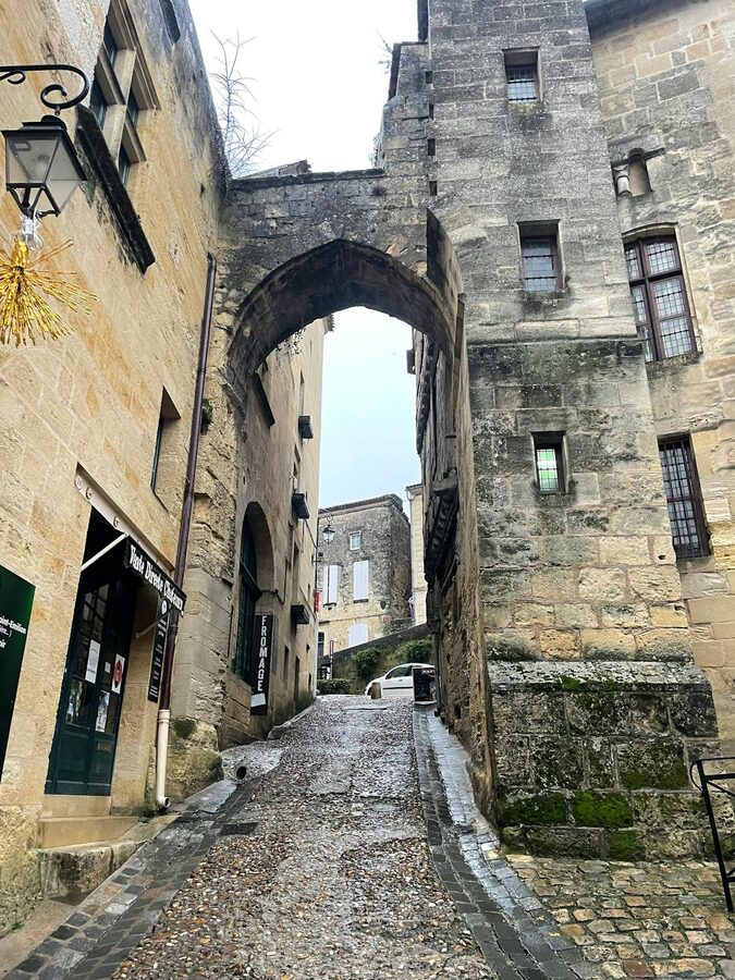 Medieval stone archway spanning a narrow lane in Saint-Émilion