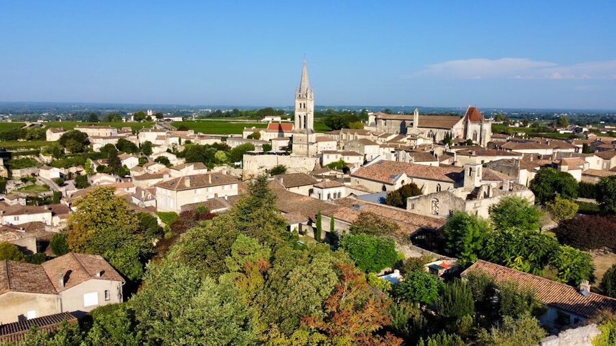 Aerial view of Saint-Émilion showing the Gothic church spire and medieval rooftops