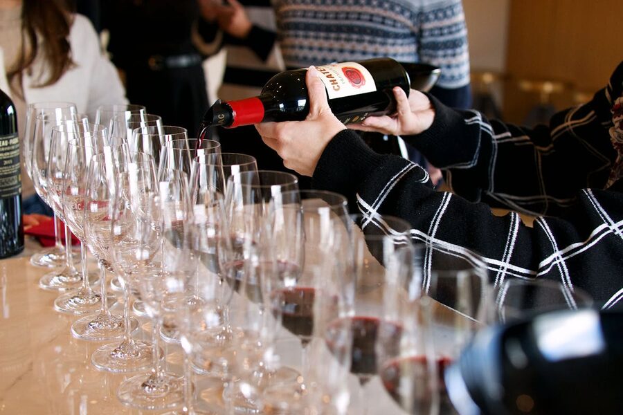 Wine tasting setup in Saint-Émilion with glasses of red wine on a wooden table
