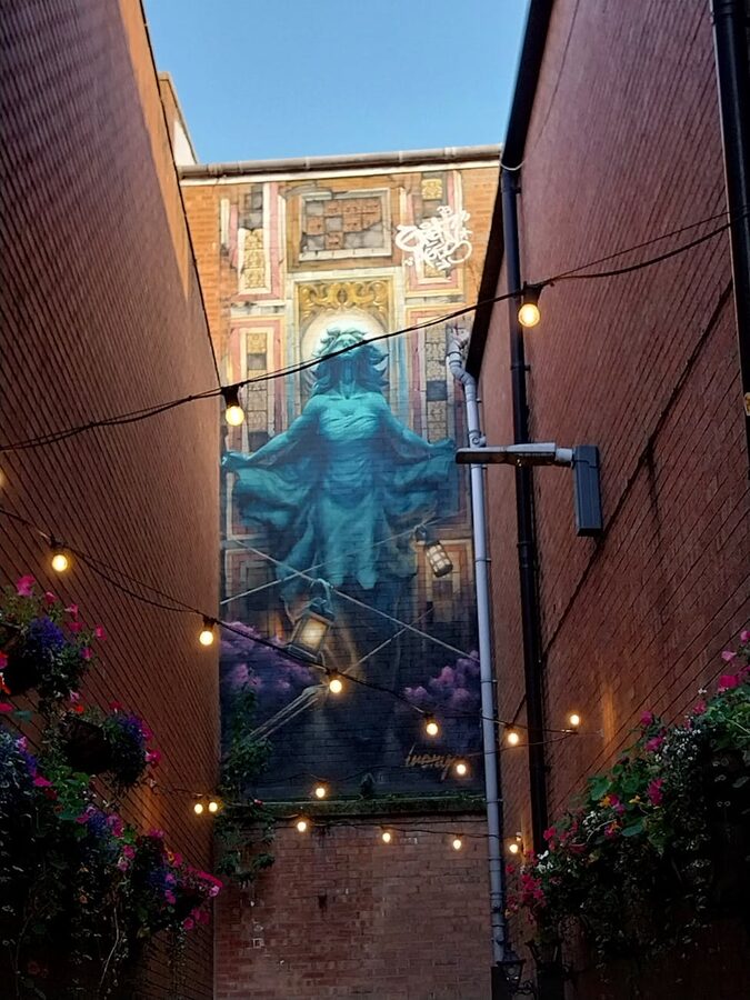 Street art mural in a Belfast alleyway with colourful designs