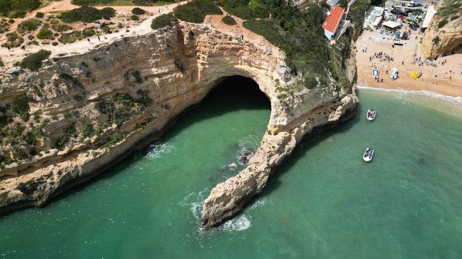 Aerial view of Benagil Cave and its small beach with turquoise water in the Algarve