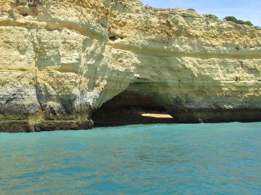 A boat approaching the entrance to Benagil sea cave in the Algarve