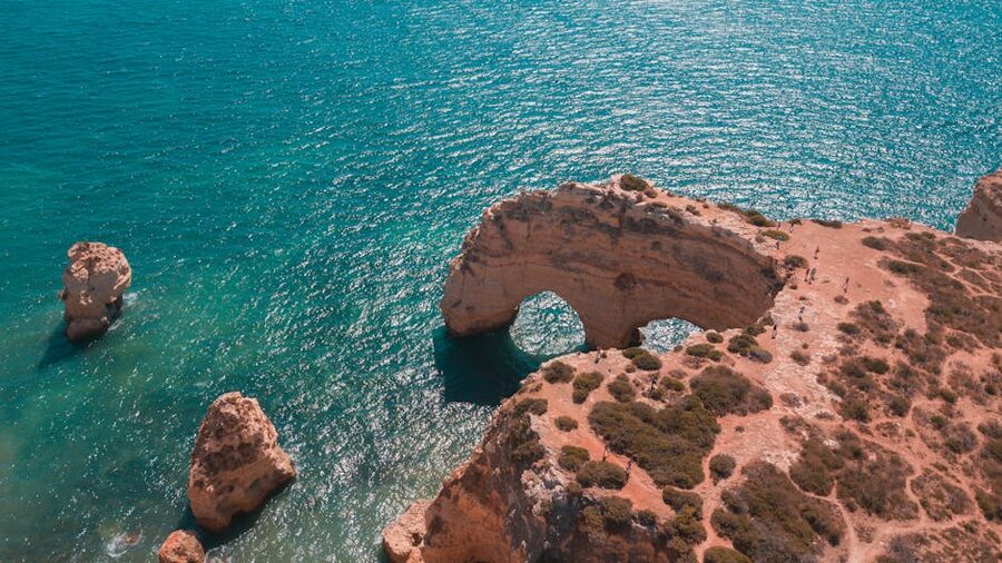 Aerial view of Marinha Beach natural rock arch Algarve Portugal