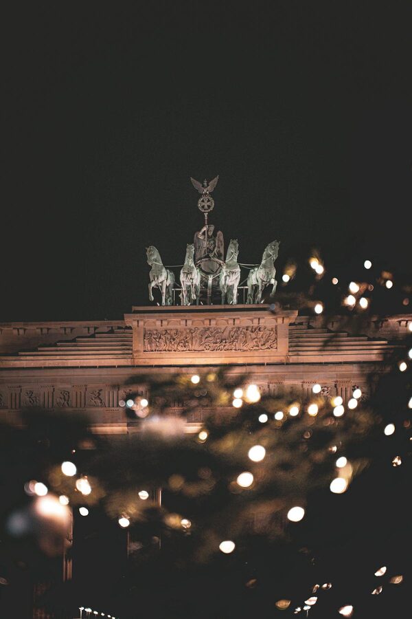Brandenburg Gate illuminated at night with festive lights in Berlin