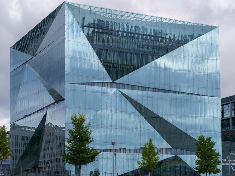 Modern glass and steel architecture in Berlin reflecting the sky
