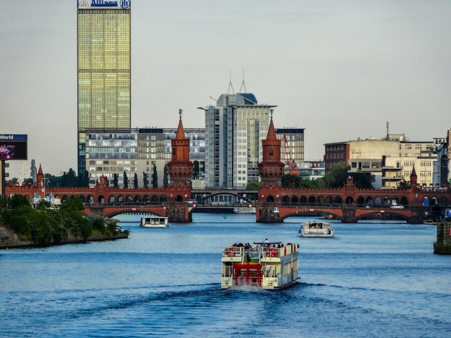 Oberbaum Bridge over the Spree River in Berlin with a ferry passing beneath