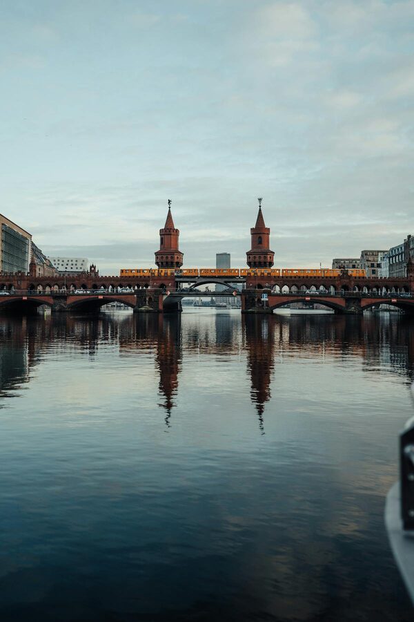 Oberbaum Bridge reflected in the Spree River at dusk in Berlin