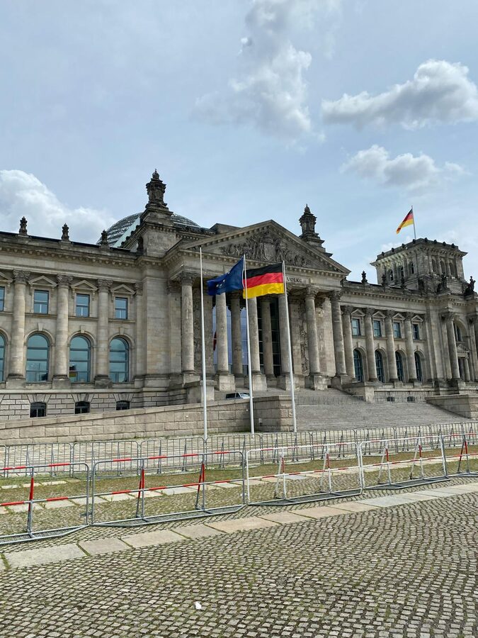 German flags flying in front of the Reichstag Building in Berlin