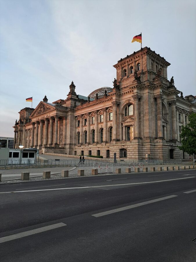 Reichstag Building in Berlin during sunset with warm golden light on the facade