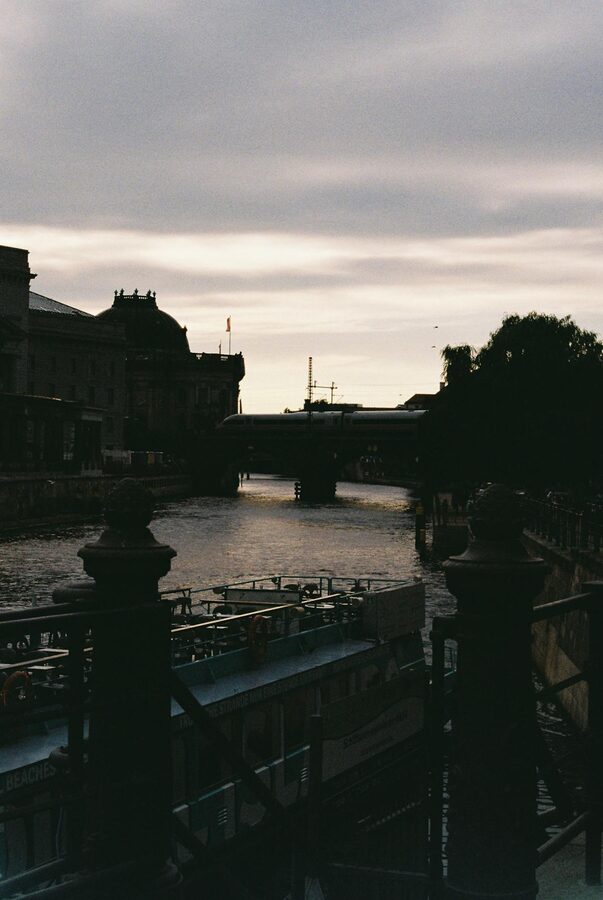 Canal and bridge in Berlin at evening with silhouetted architecture