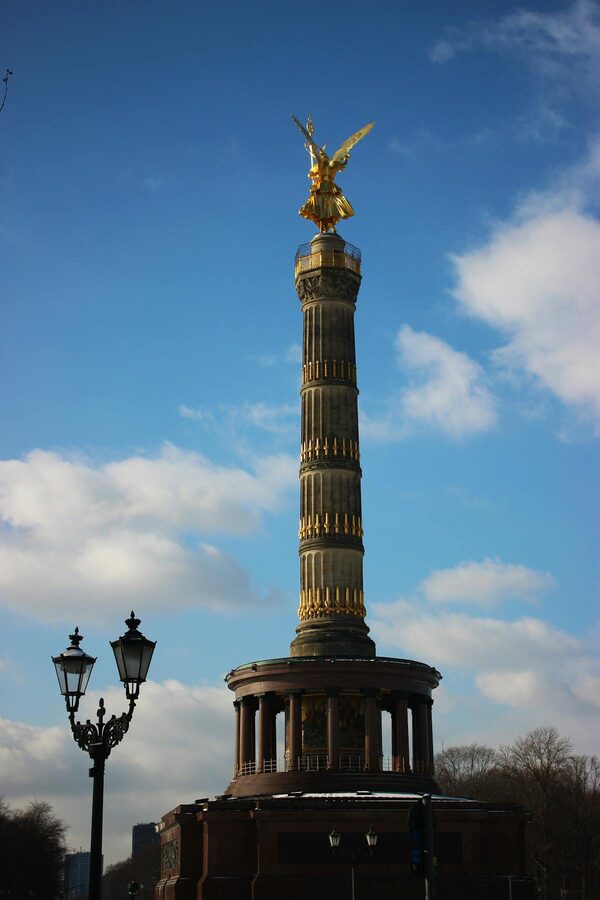 Victory Column in Berlin rising against bright blue sky