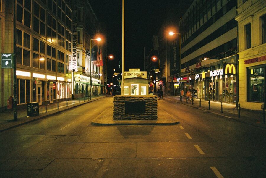 Checkpoint Charlie area illuminated at night in Berlin